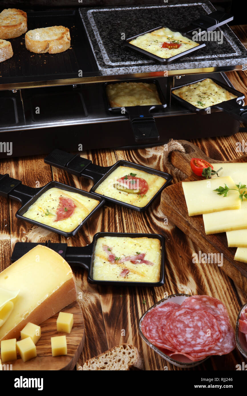 Delicious traditional Swiss melted raclette cheese served in individual ...