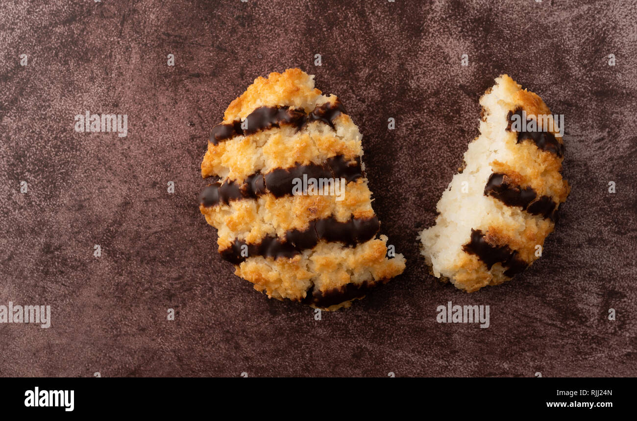 Overhead view of a single dark chocolate striped coconut macaroon ...