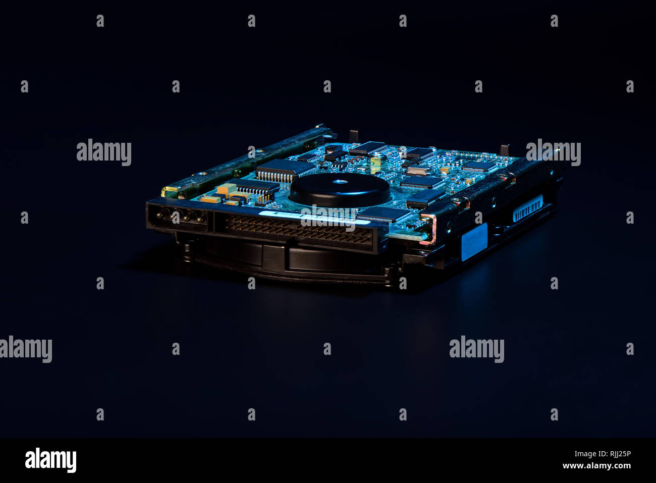 Used hard disk isolated on black background and blue backlight. Dusty ...