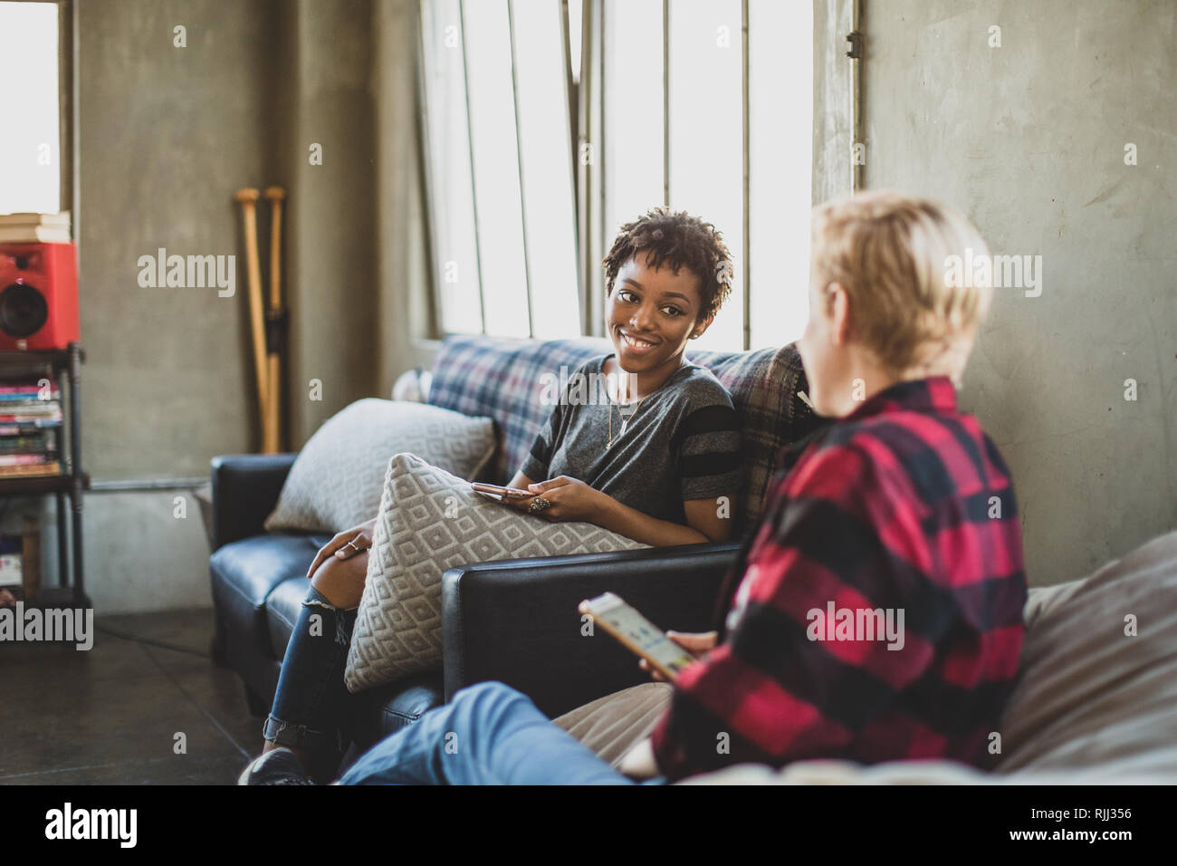 Young adult friends socialising whilst hi-res stock photography and ...