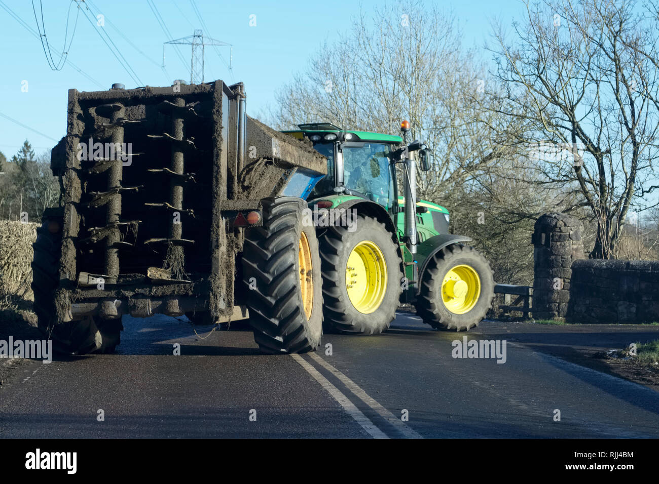 Tractor agriculture vehicle turning on road with crop machine Stock ...