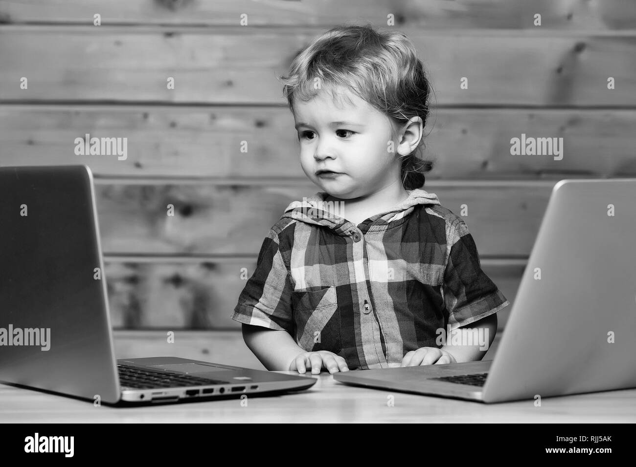Cute boy plays on computers Stock Photo - Alamy