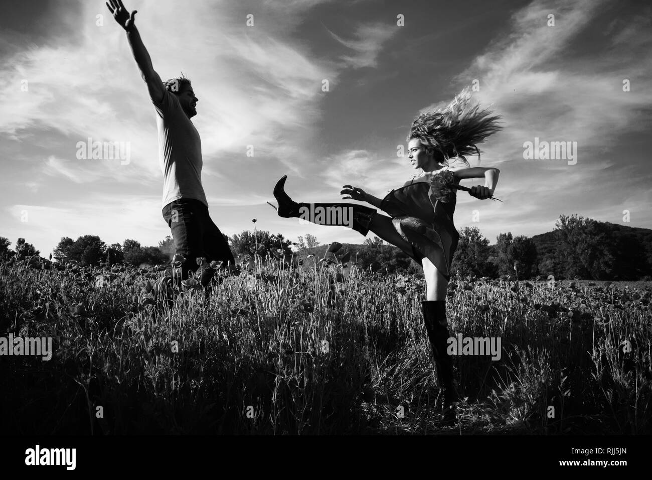 couple dancing in red poppy field Stock Photo - Alamy