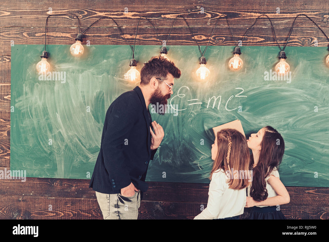 Tutor teach children students in classroom. Teacher write with chalk on ...