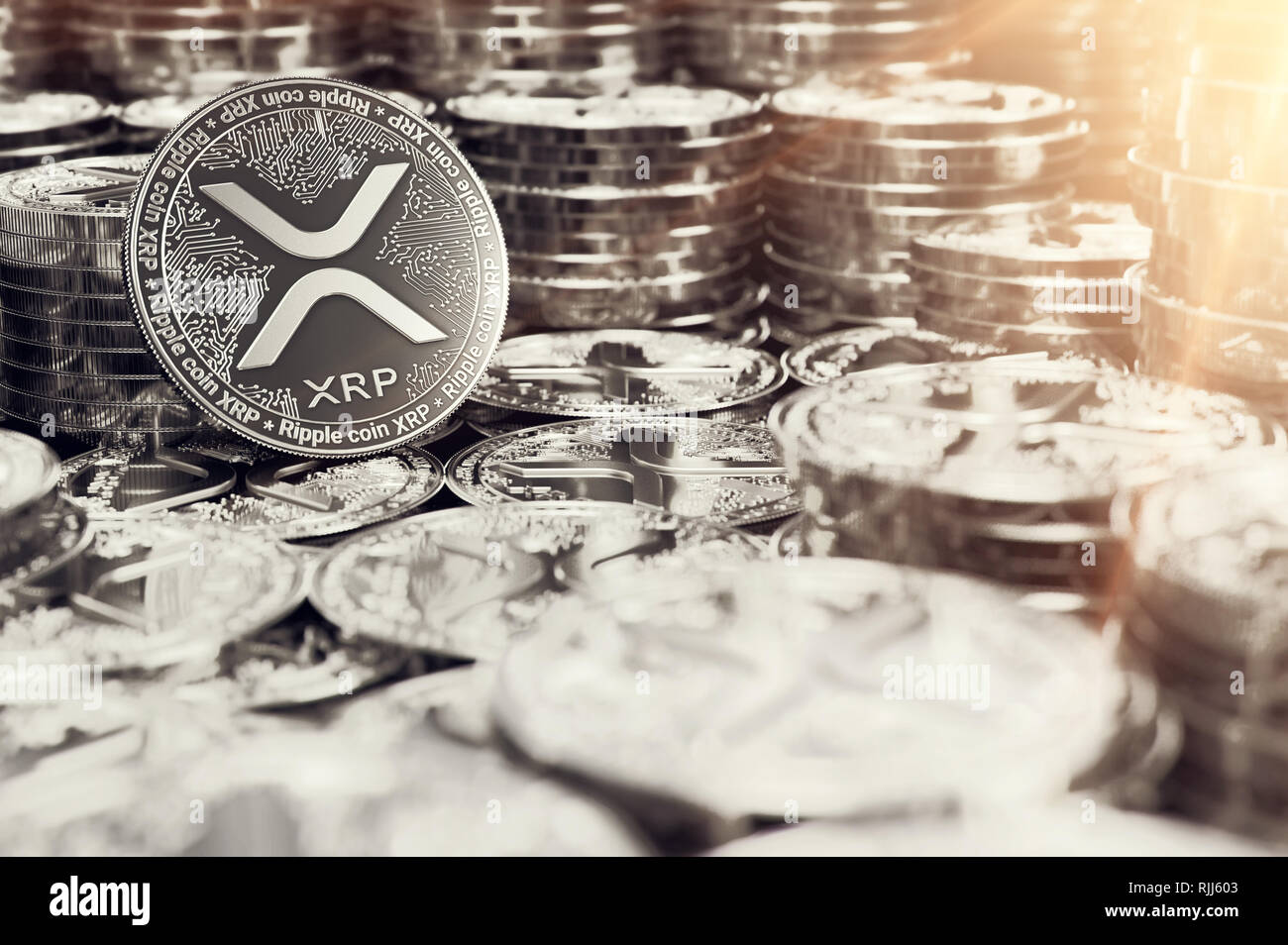 Stack of silver Ripple XRP coins in blurry closeup with lens flare as a ...