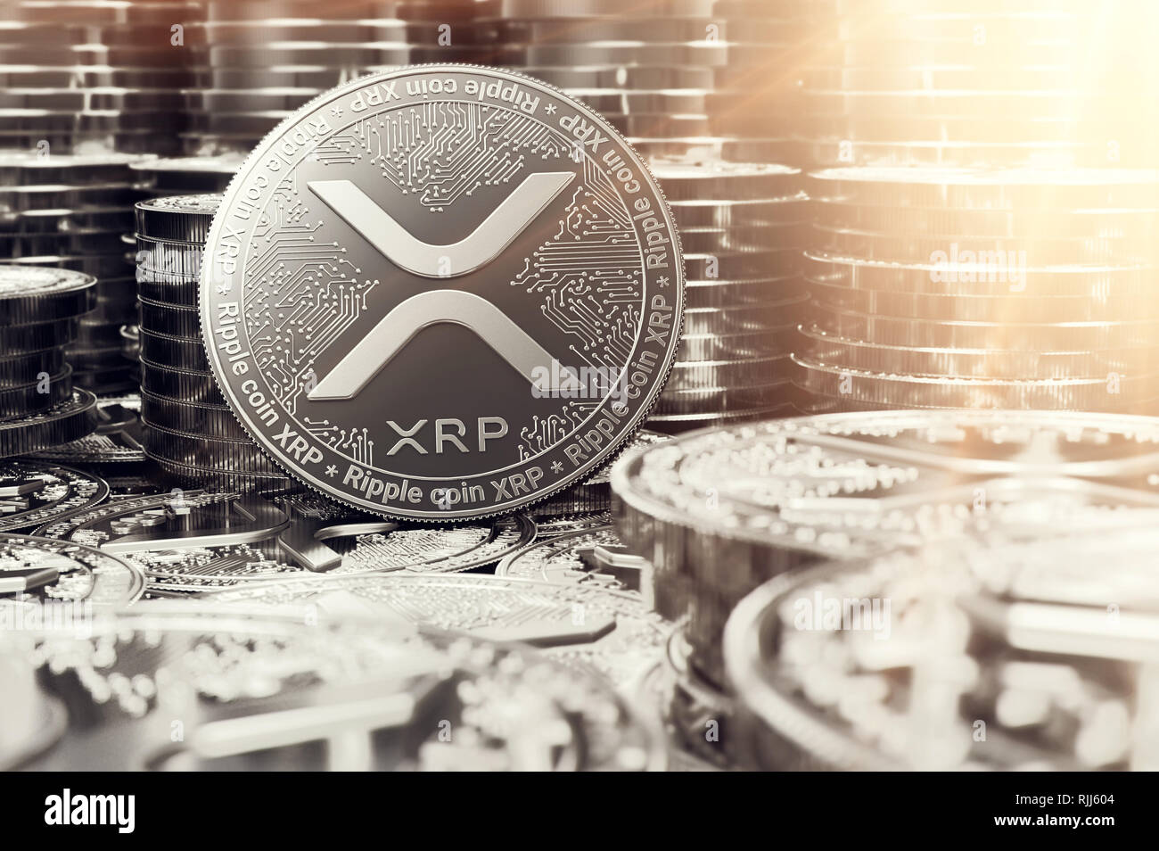 Stack of silver Ripple XRP coins in blurry closeup with lens flare as a ...