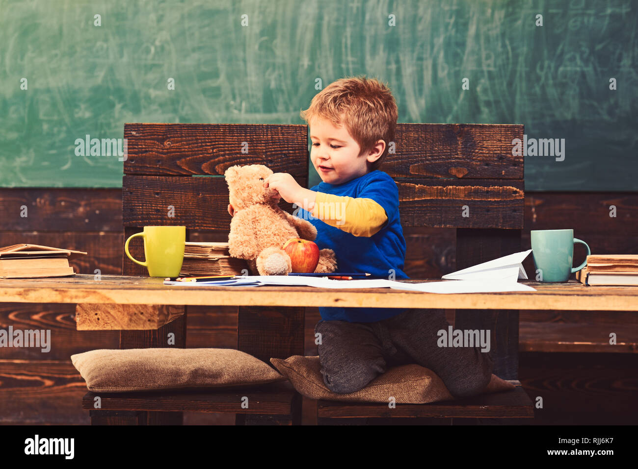 Small boy playing with teddy bear during school break. Cute kid with ...