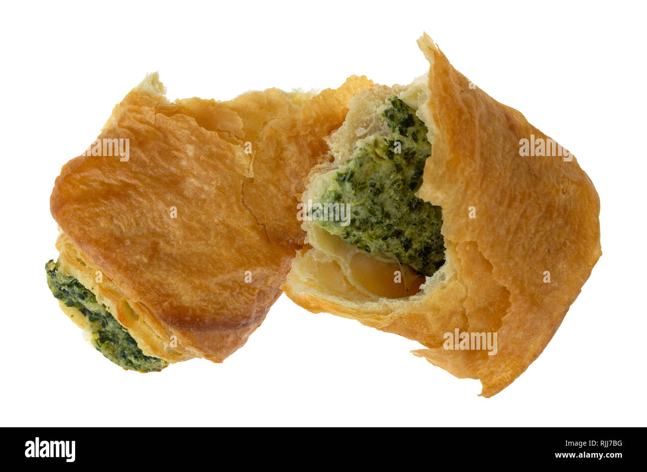 Side view of a broken pastry with a spinach filling isolated on a white ...