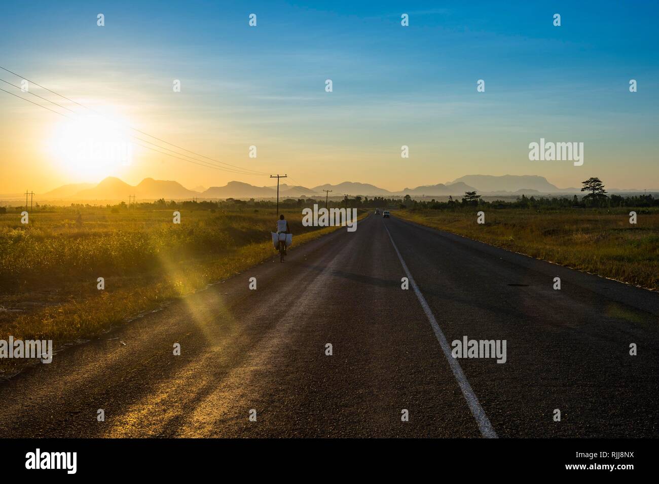Road with sunset and backlight at Mulanje massiv, Malawi Stock Photo ...