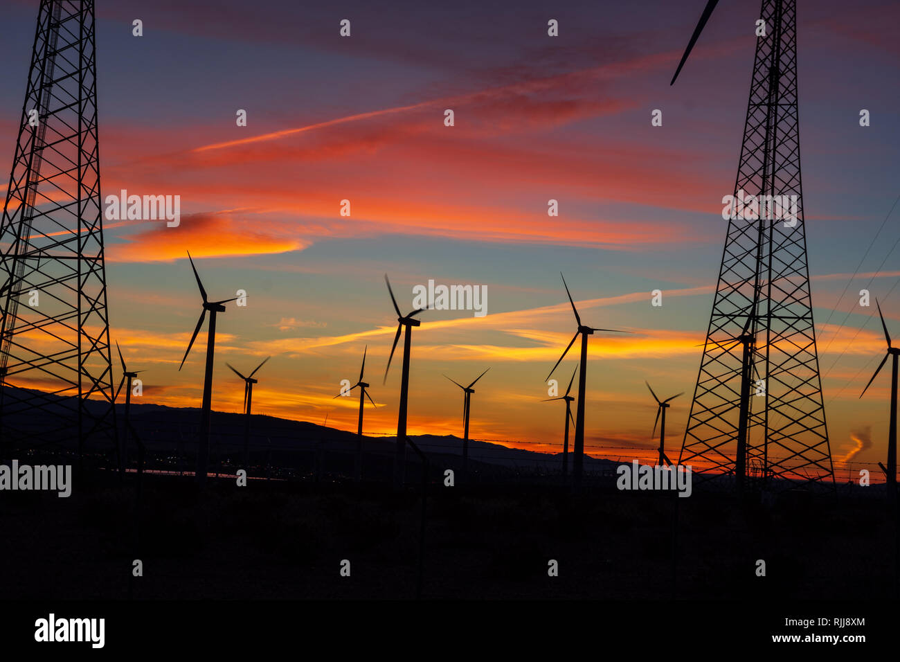 Red sunrise over valley with working wind turbines Stock Photo - Alamy