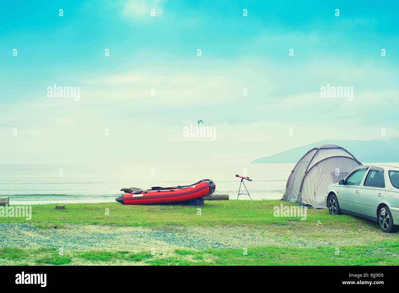 Seascape summer travel machine tent rubber boat. Coastline horizon sky ...