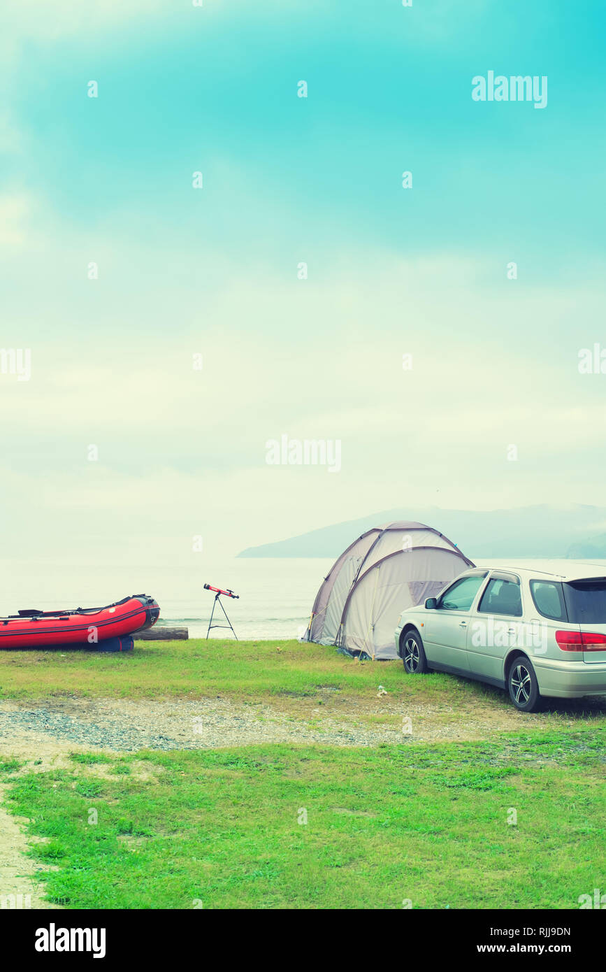 Seascape summer travel machine tent rubber boat. Coastline horizon sky ...