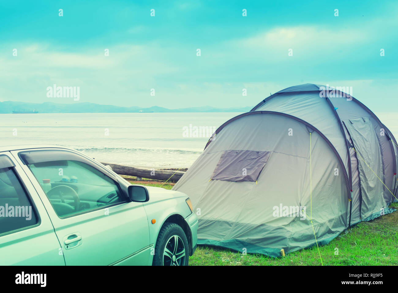 Seascape summer travel machine tent rubber boat. Coastline horizon sky ...