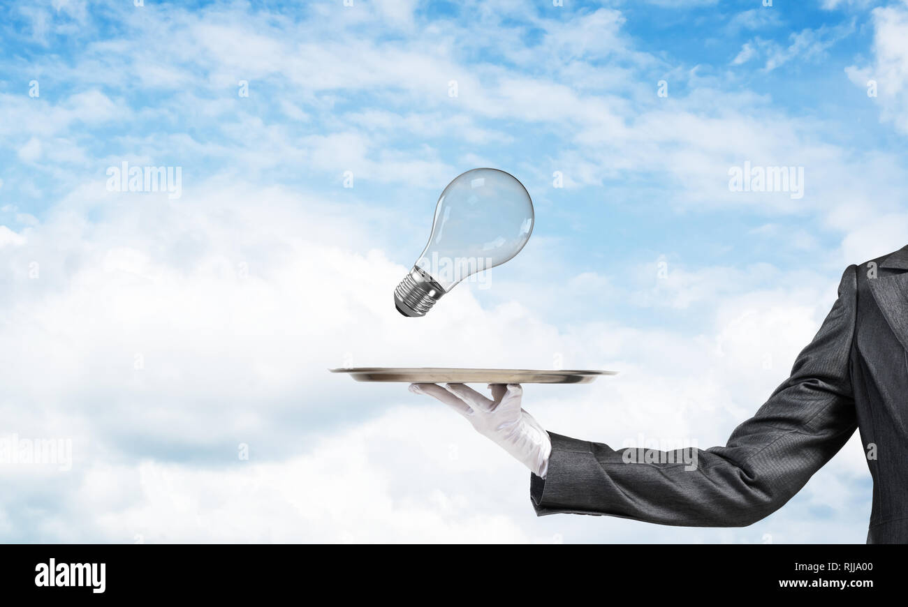 Hand of waitress presenting lightbulb on tray Stock Photo - Alamy