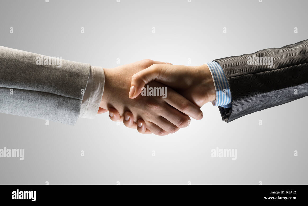 Business handshake as idea for unity and cooperation or greeting. Mixed ...