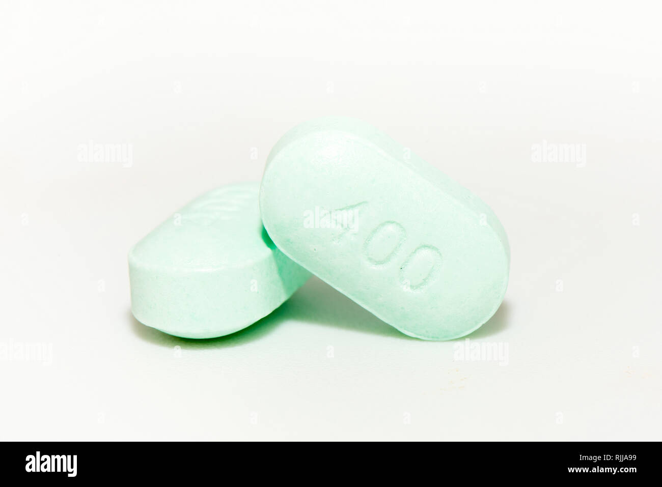 green tablets of medicine isolated on white background Stock Photo - Alamy