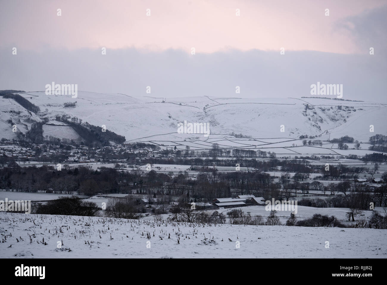 Snowy dawn in the Peak District National Park, England. Twilight light ...