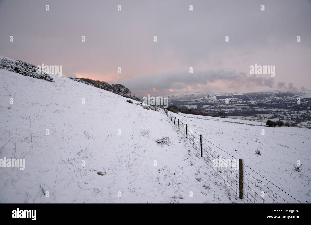 Snowy dawn in the Peak District National Park, England. Twilight light ...