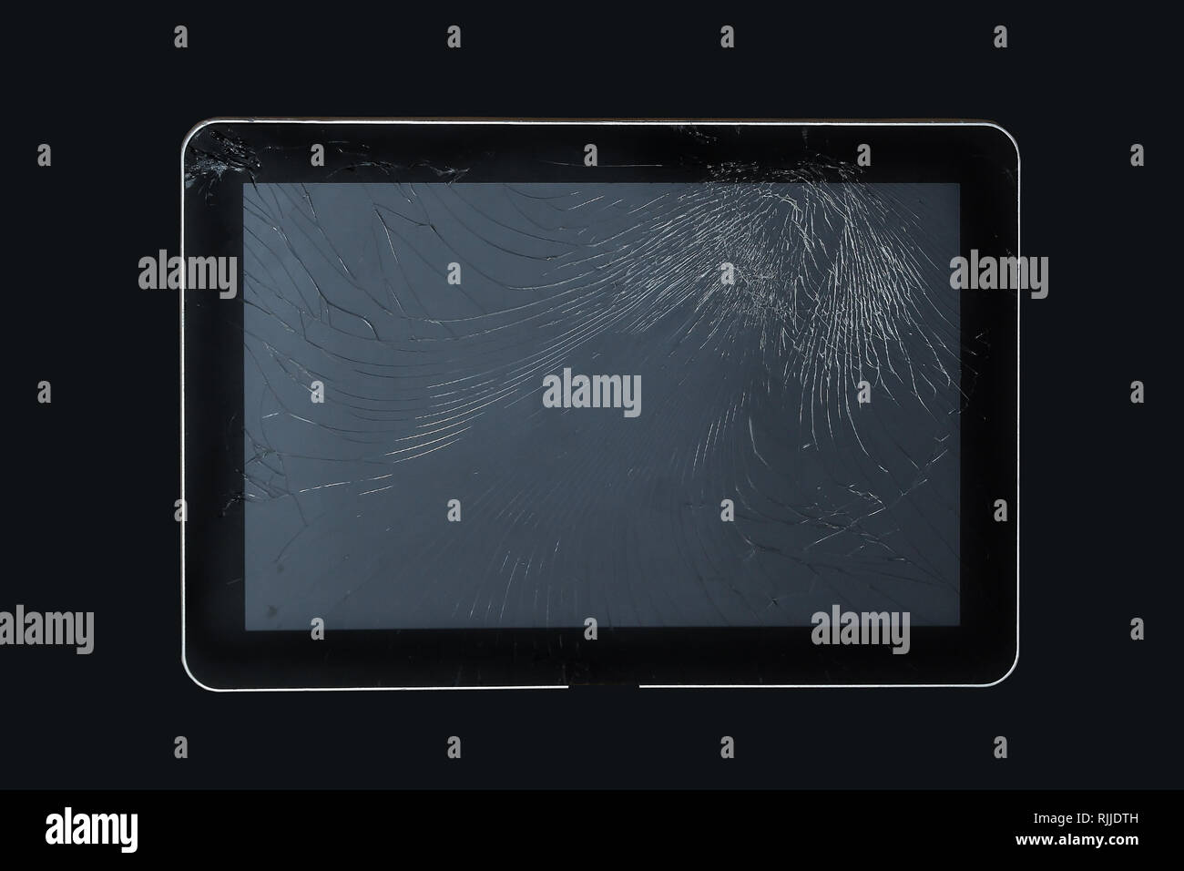 Damaged broken screen glass on modern tablet device isolated on black ...