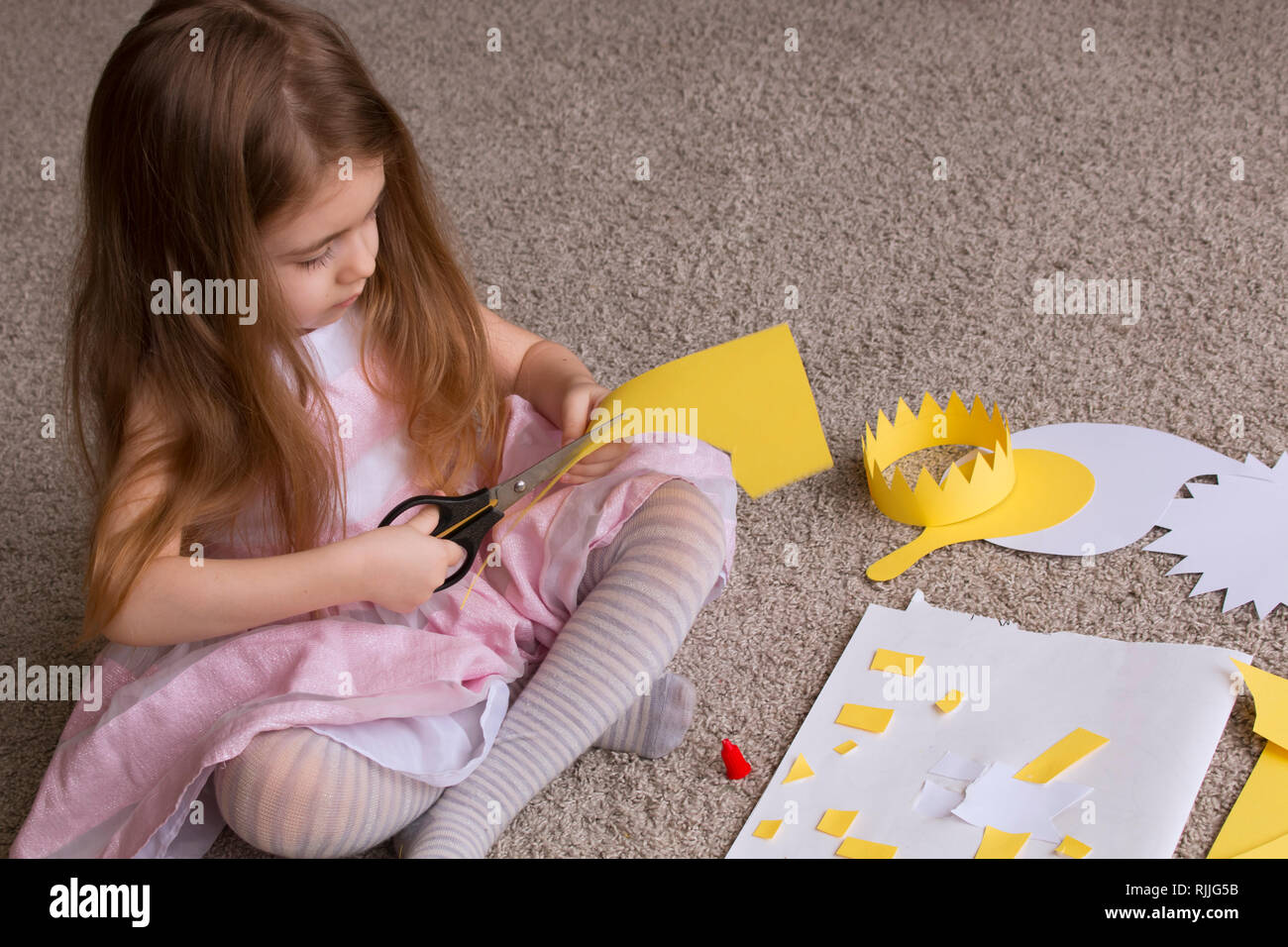 Cute little 4 years old girl making crafted applied ornament with ...