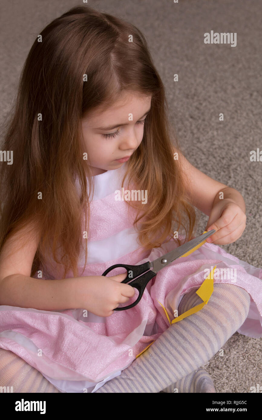 Cute little 4 years old girl making crafted applied ornament with ...