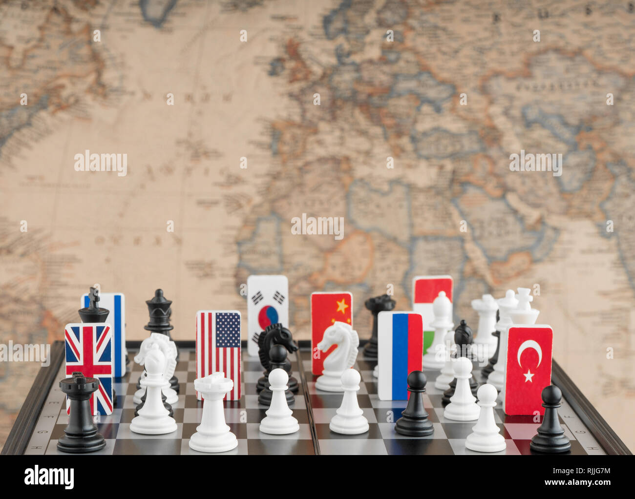 Country flag symbols on the chessboard with figures on the background ...