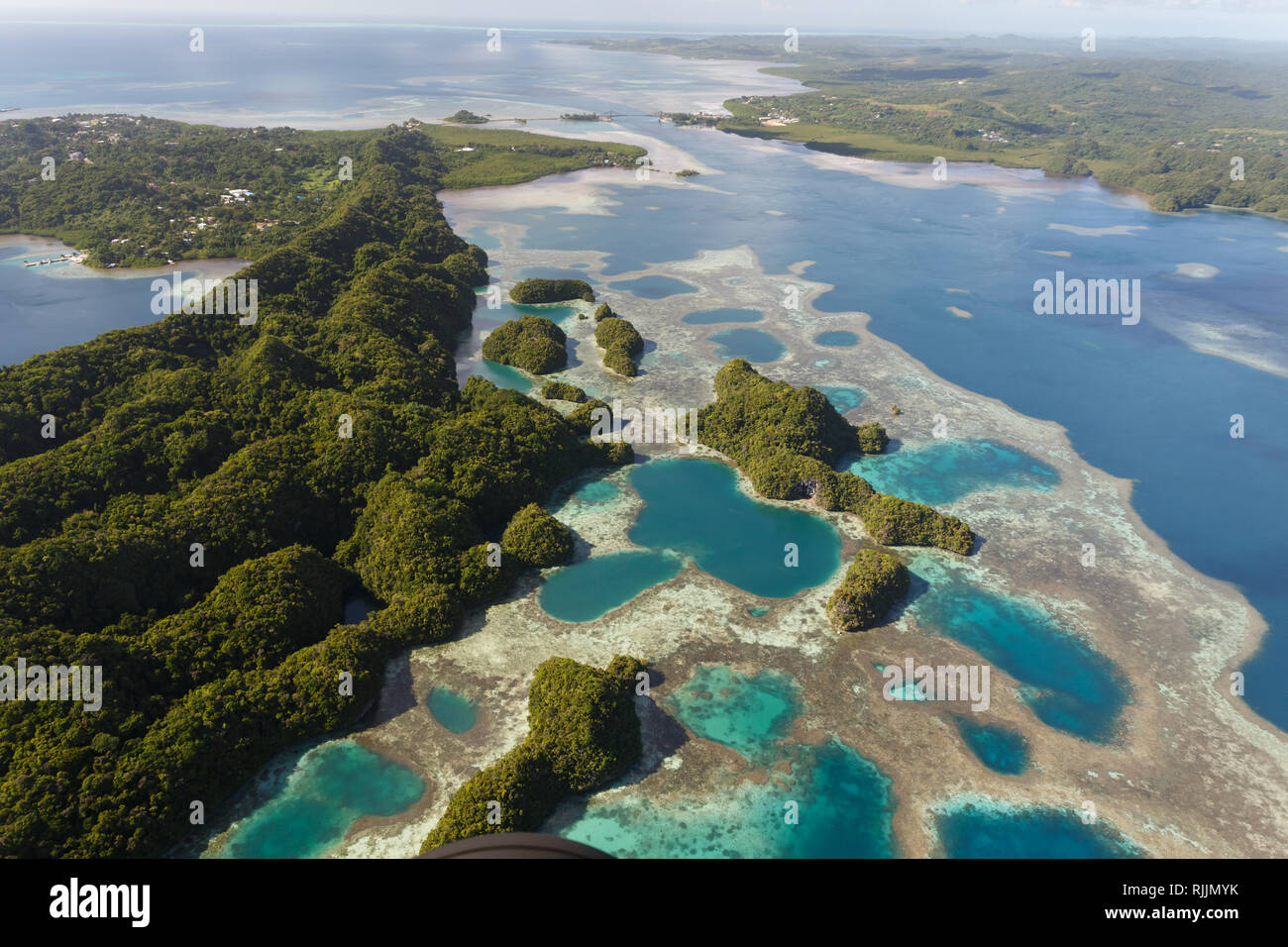 Aerial landscape of green islands, coral reefs, near town of Koror ...