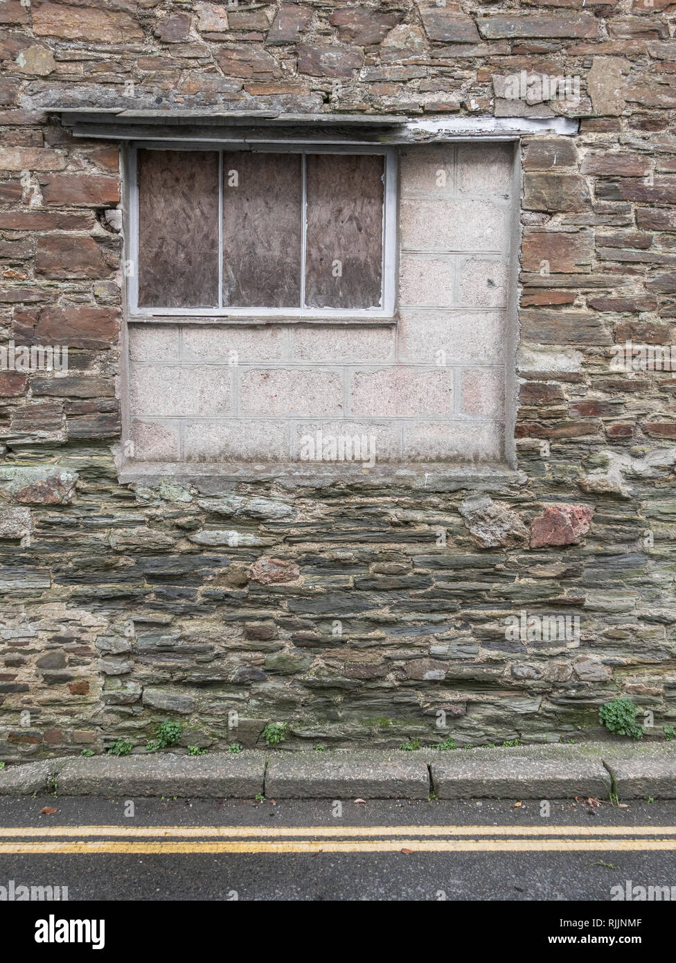 Partially bricked-up window in an outhouse building Stock Photo - Alamy