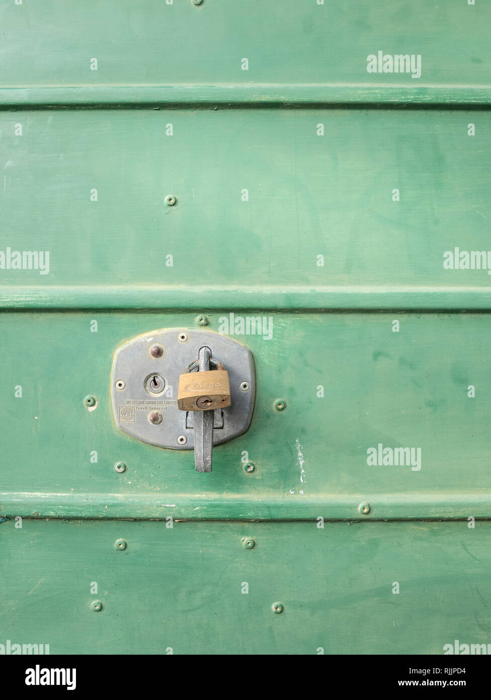 Brass padlock securing lock-up uni. Locked in place, lock in place ...