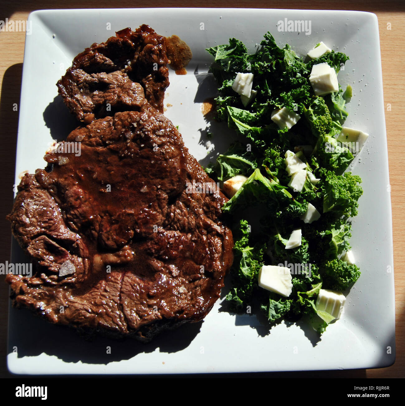 Beef steak with kale Stock Photo - Alamy