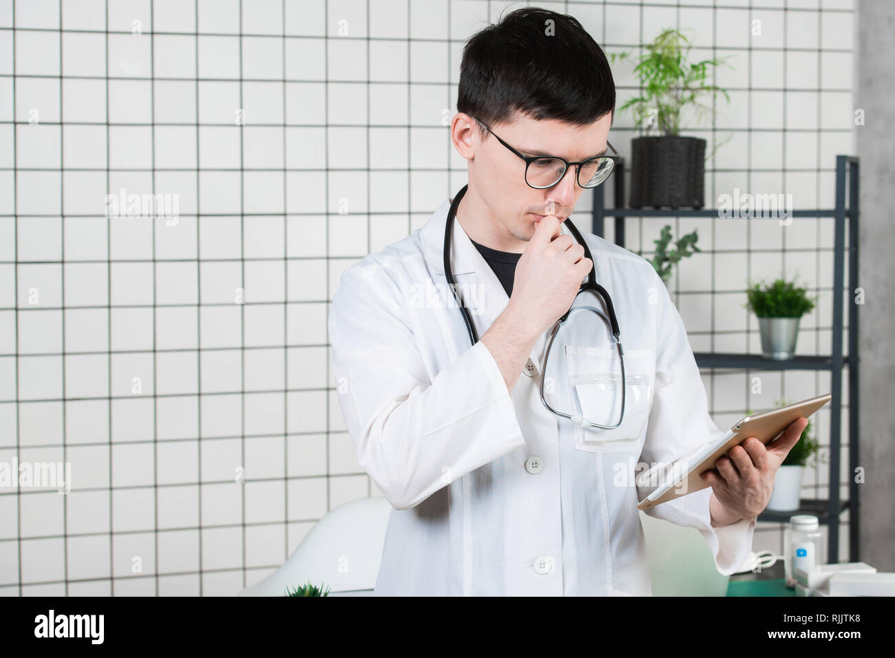 Pensive doctor analyzing medical history and thinking over treatment ...