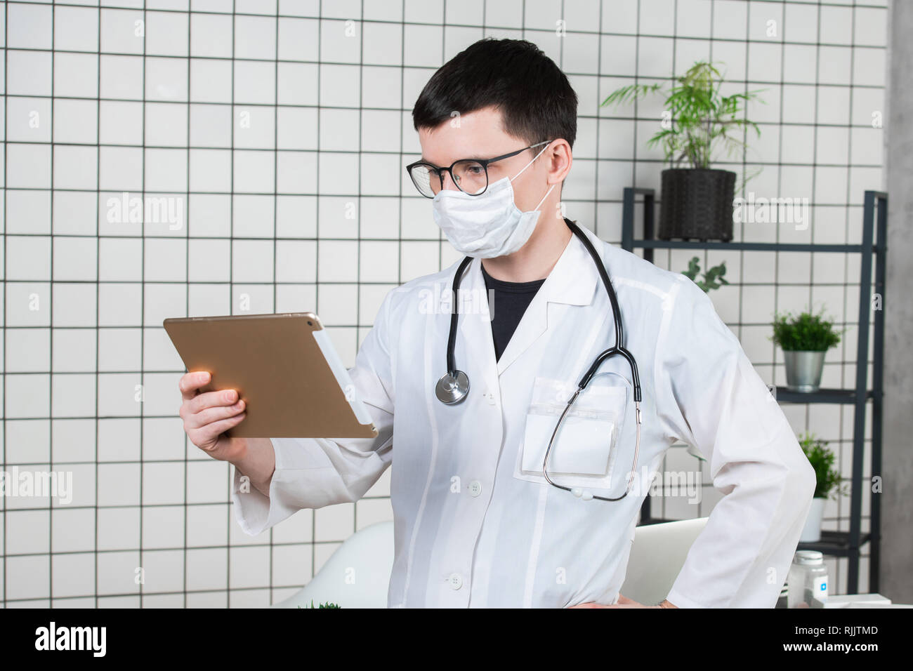 Surgeon doctor with tablet computer in hospital office. Medical ...