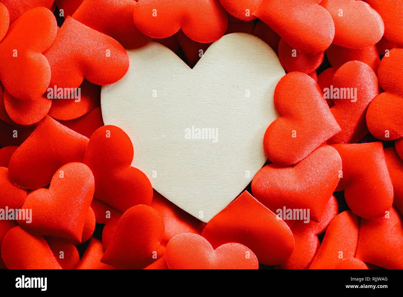 Large empty wooden heart surrounded by small red hearts for Valentine's ...