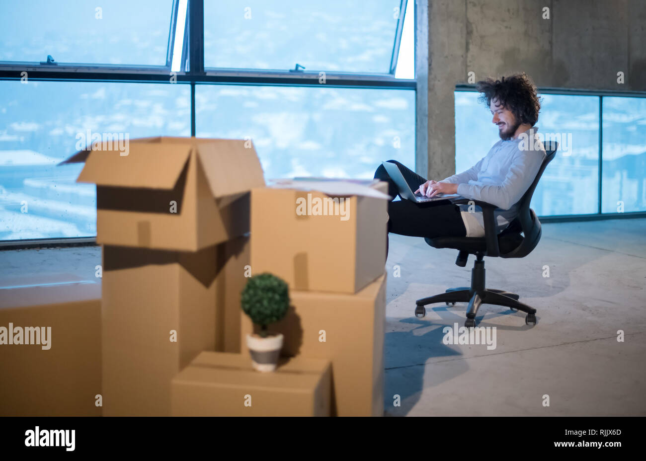 young male architect on construction site checking documents and ...