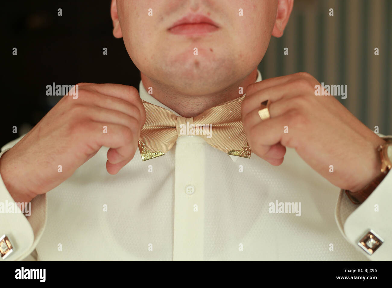 man correct his butterfly in a white shirt. Photo of a male butterfly ...