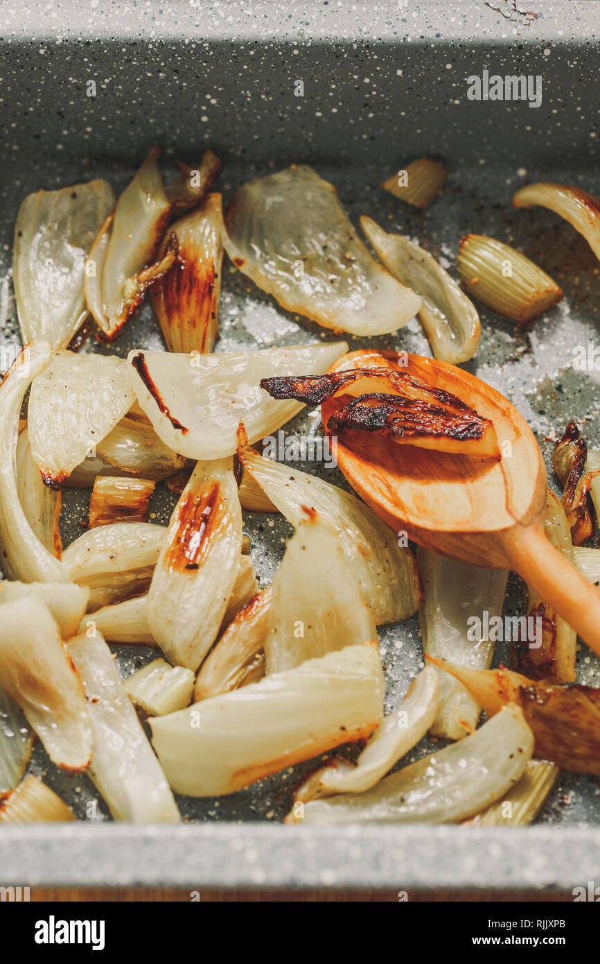 Roasted fennel in a baking pan with olive oil. Tasty vegetarian recipe ...