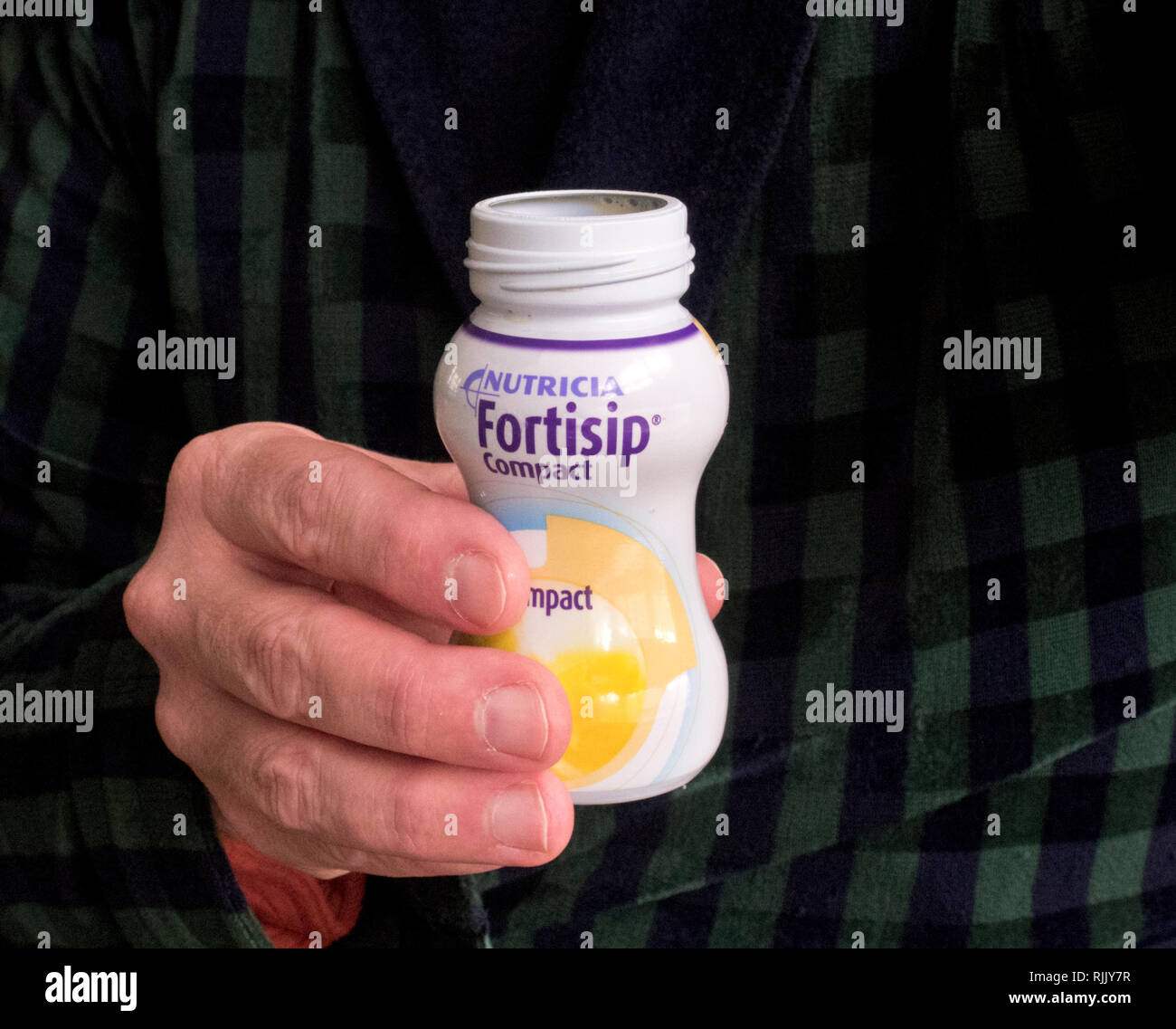 Caucasian Man Holding a Nutricia Fortisip Compact Vanilla Fortified ...