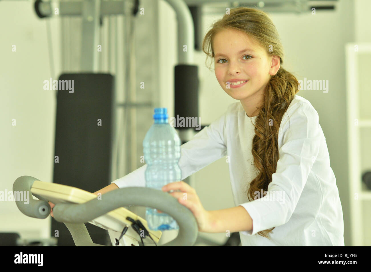 Portrait of cute little girl doing exercises Stock Photo - Alamy