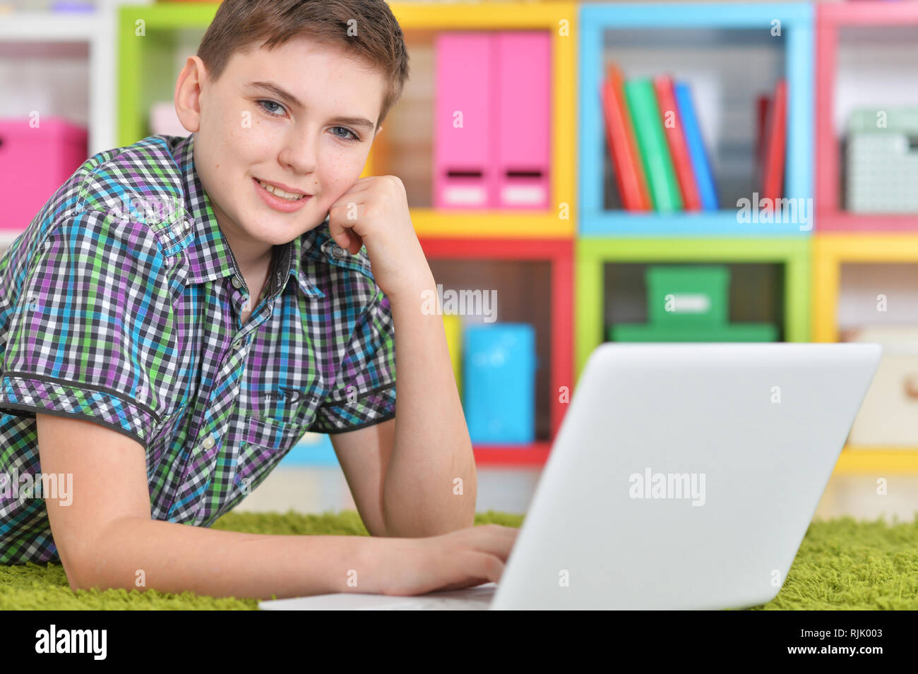 Teen boy lying laptop hi-res stock photography and images - Alamy