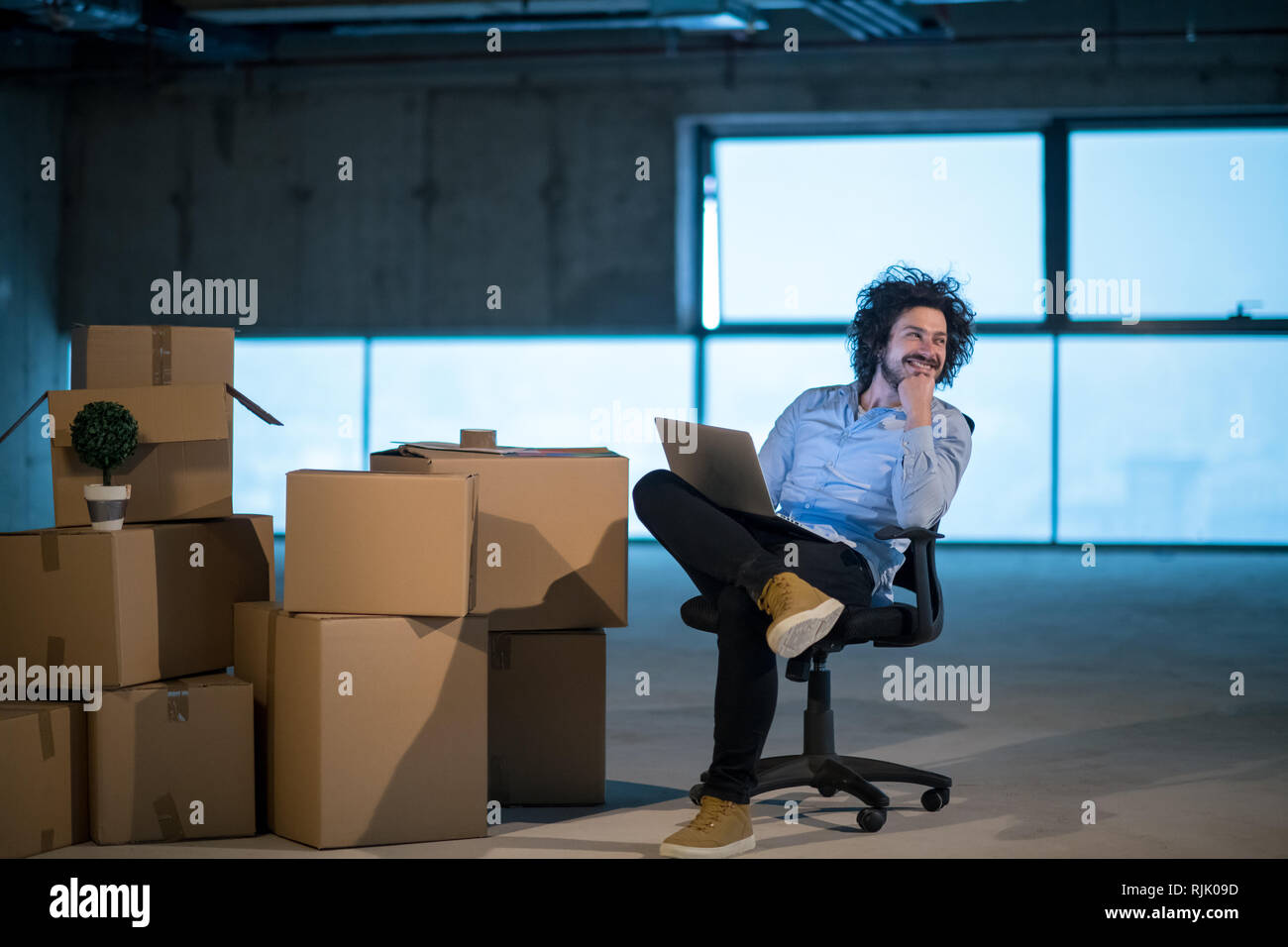 young male architect on construction site checking documents and ...