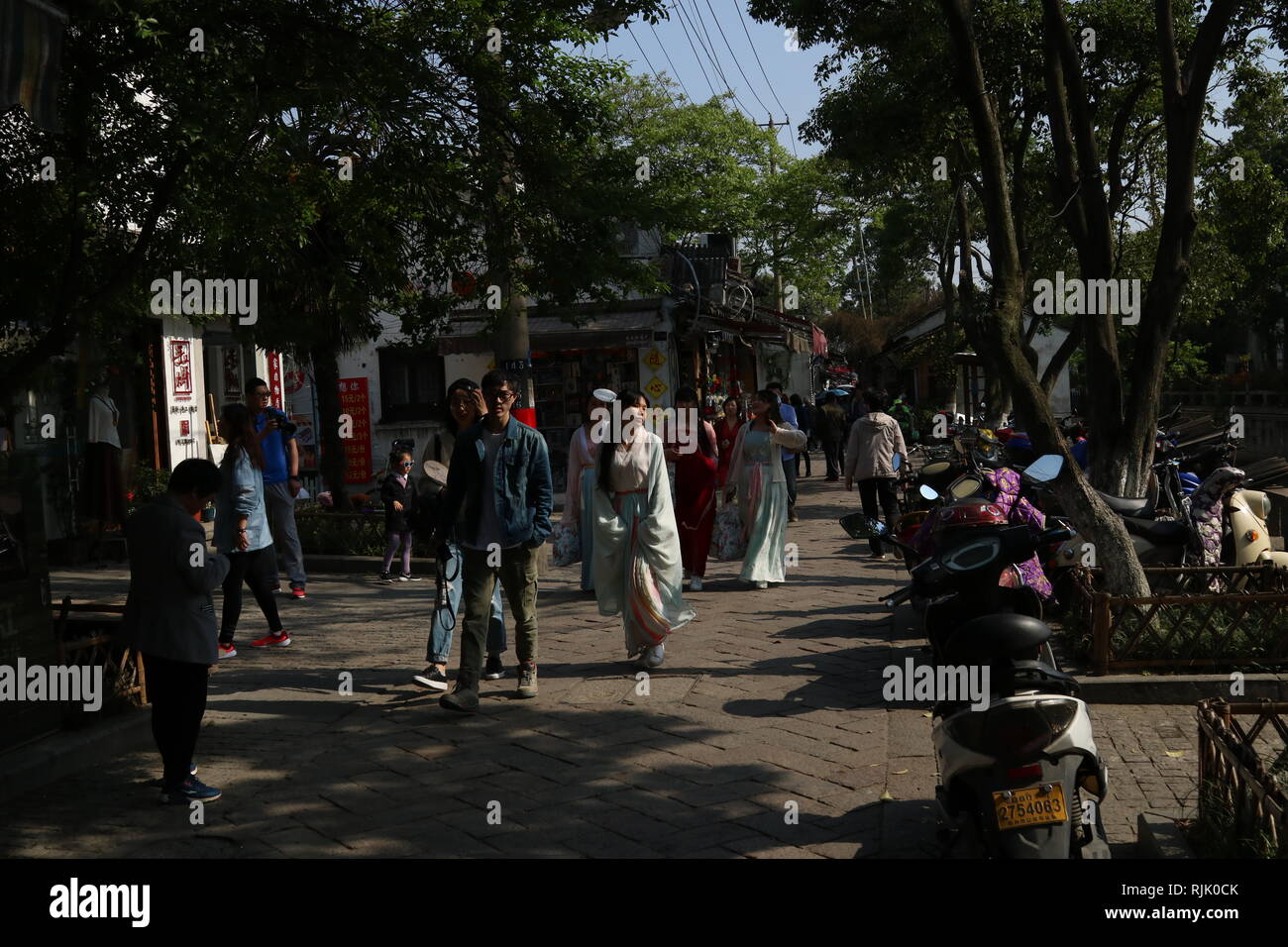 Suzhou, Jiangsu, elegant in traditional costume walking in a tourist ...