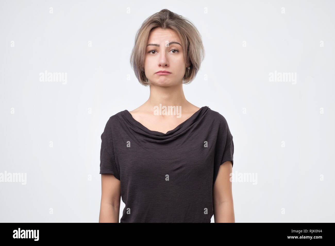 Sad woman serious and concerned looking worried and thoughtful at ...