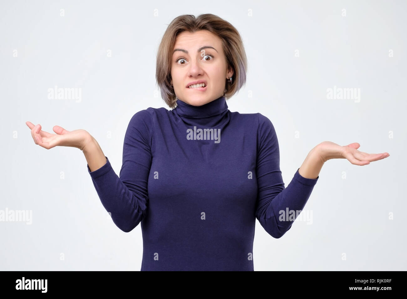 Young girl shrugging shoulders. I do not know why are you shouting on ...