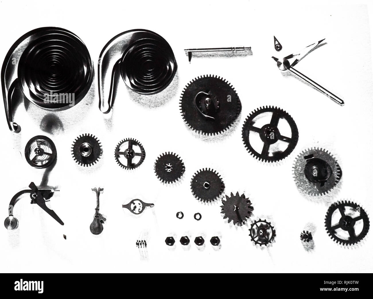 A photograph of moveable parts of a modern alarm clock. Dated 20th ...
