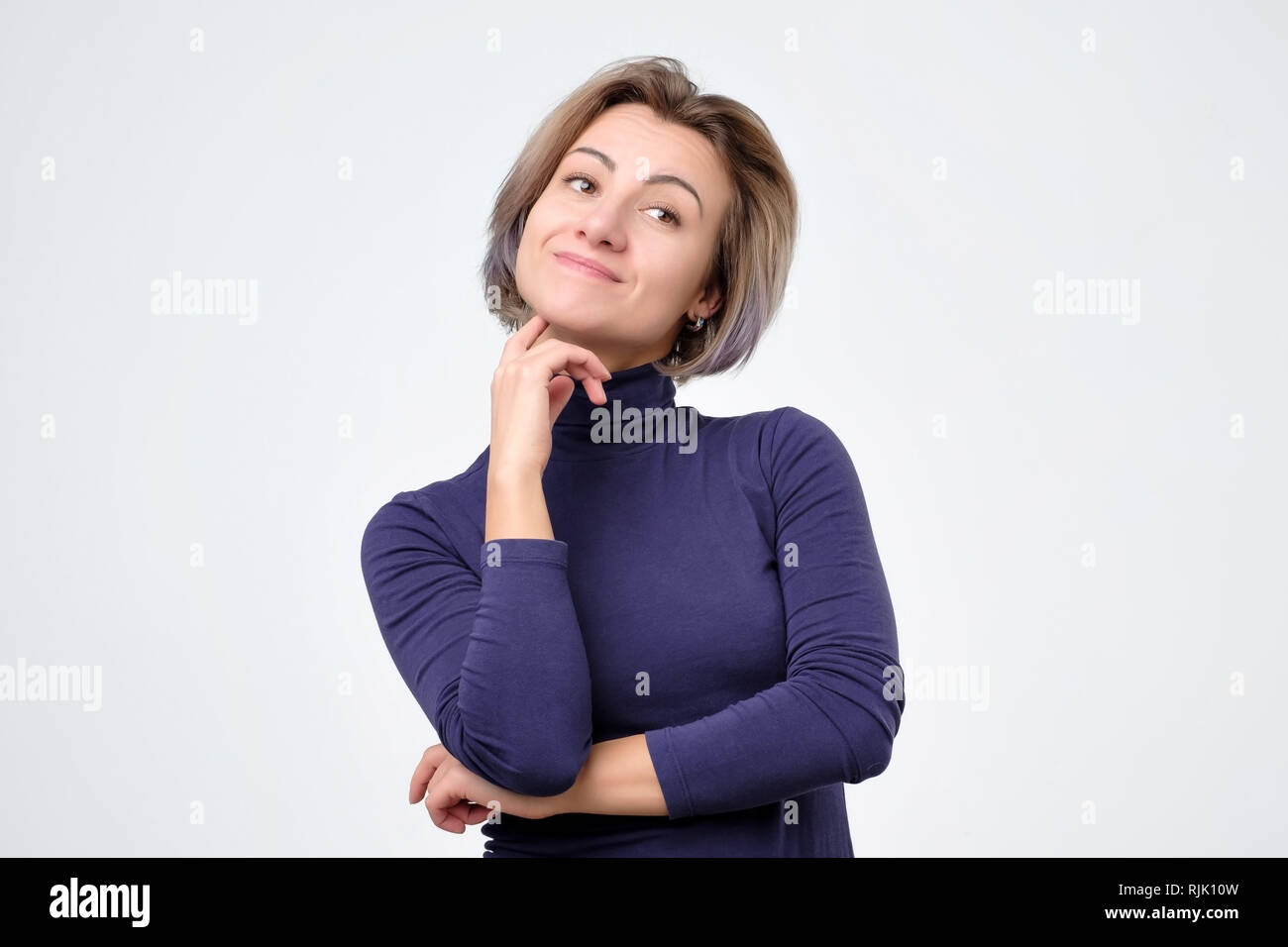 Woman thinking about thing she desire with intrigued and interested ...