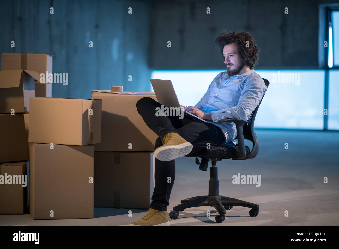 young male architect on construction site checking documents and ...