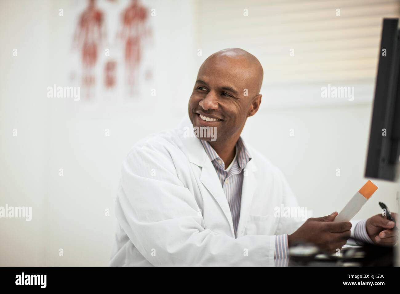 Male doctor lab coat holding medicine hi-res stock photography and ...