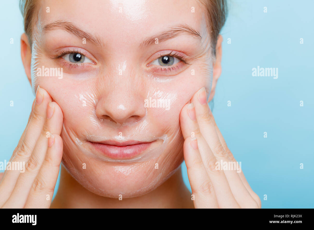 Young woman in facial peel off mask. Peeling. Beauty and skin care ...