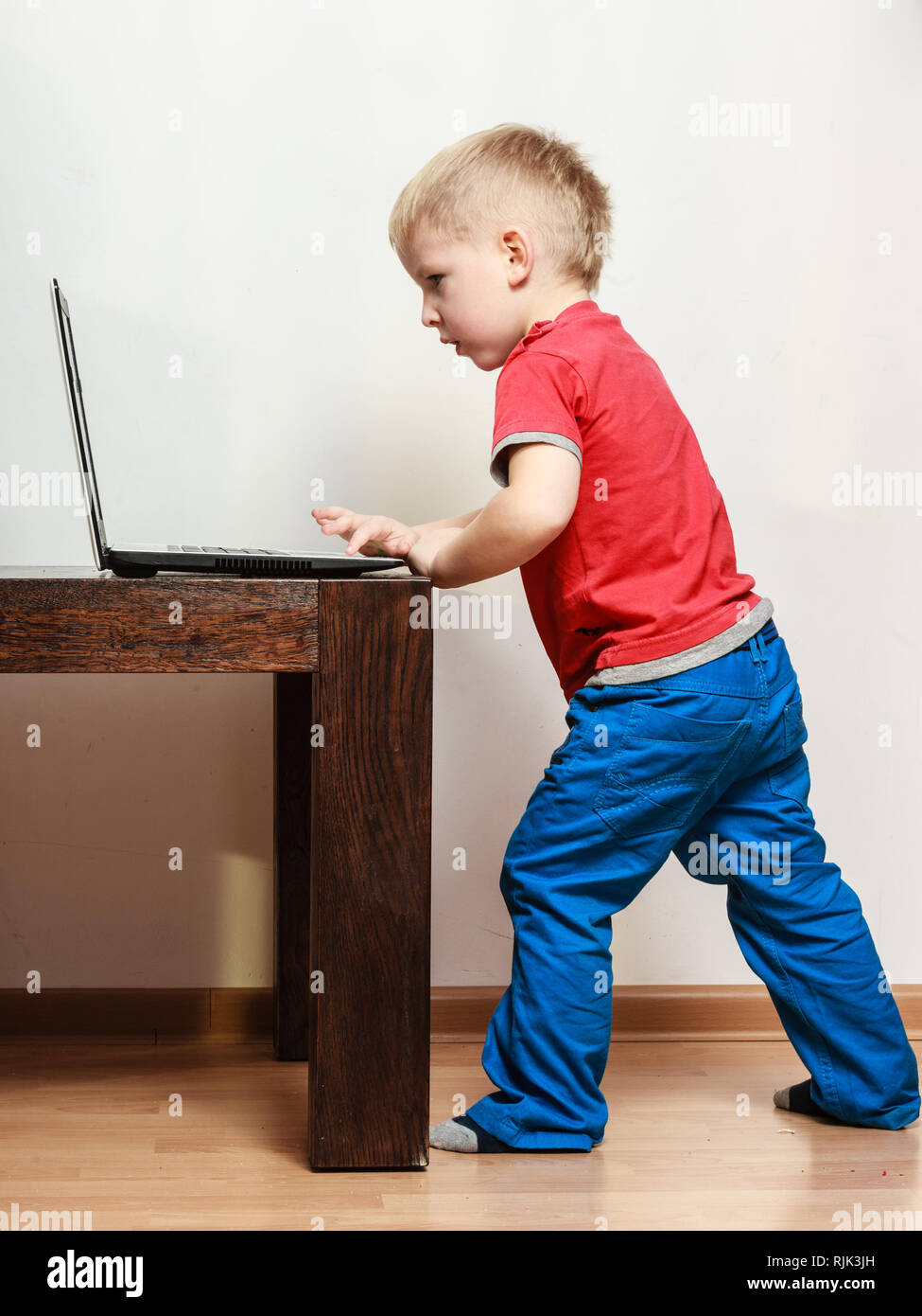 Technology and child. Preschooler boy playing on computer. Leisure ...