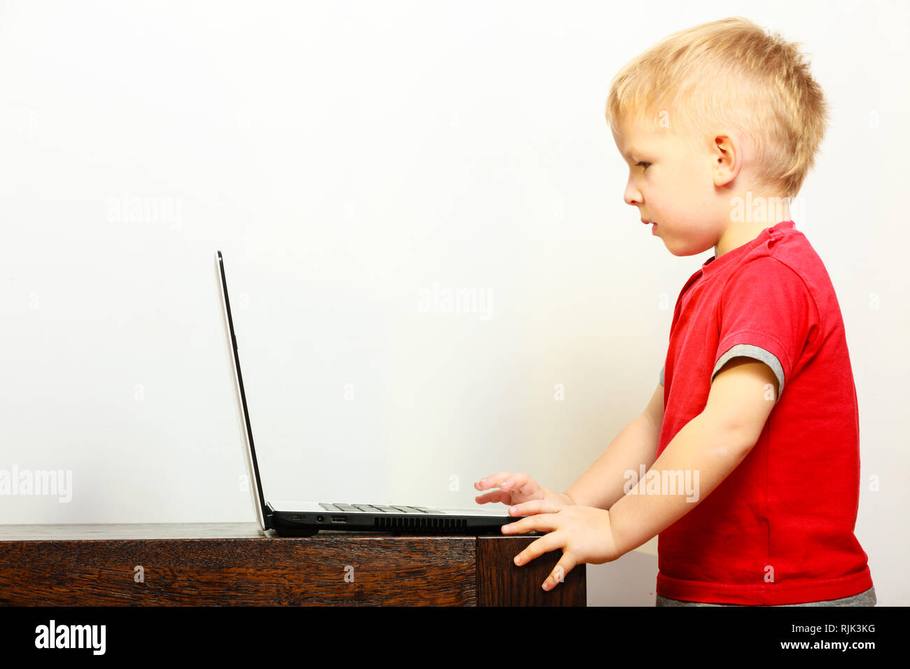 Children, technology and home concept - little boy kid child using ...